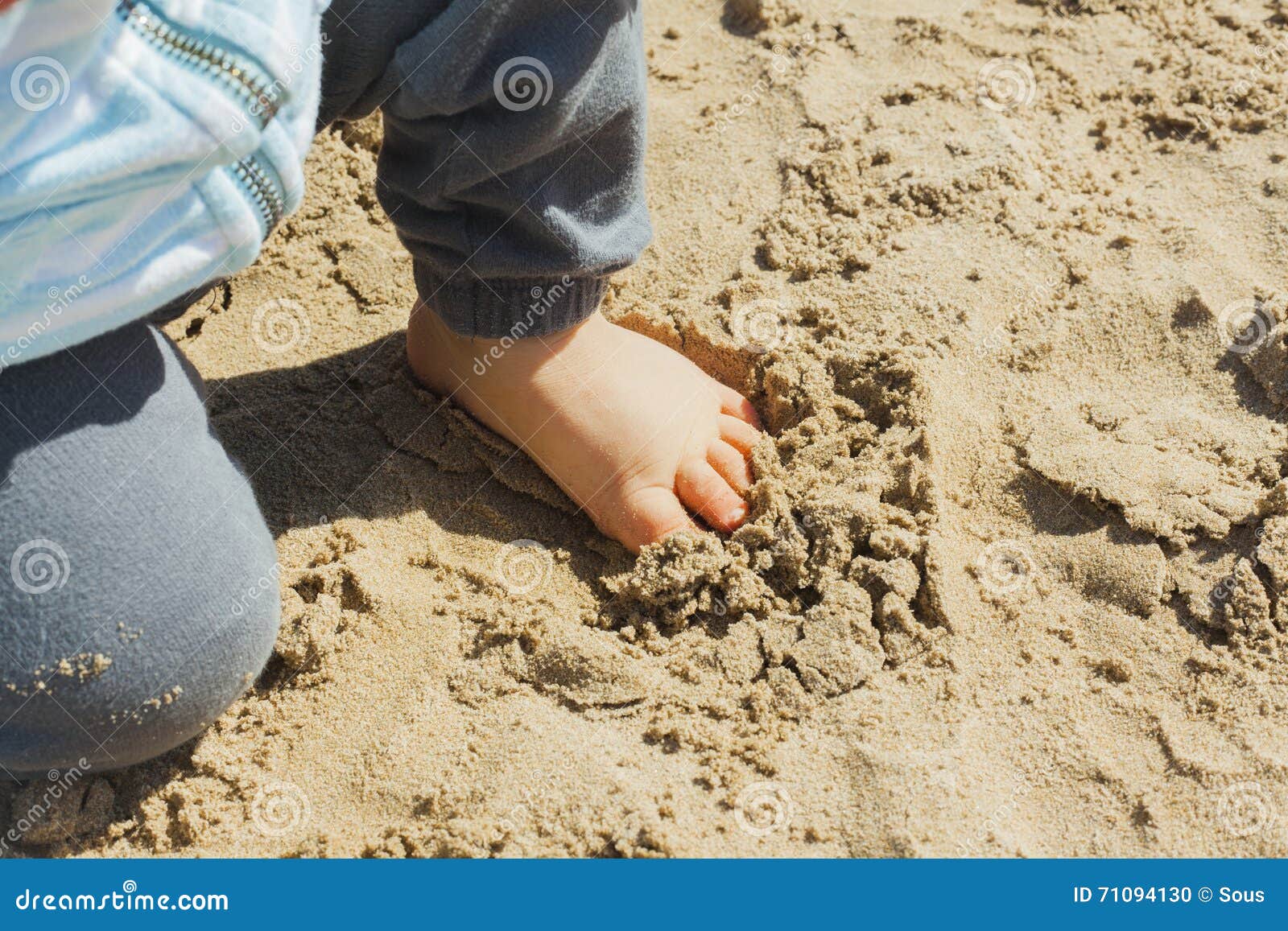 Baby Boy Touching the Sand with His Foot at the Beach Stock Photo ...