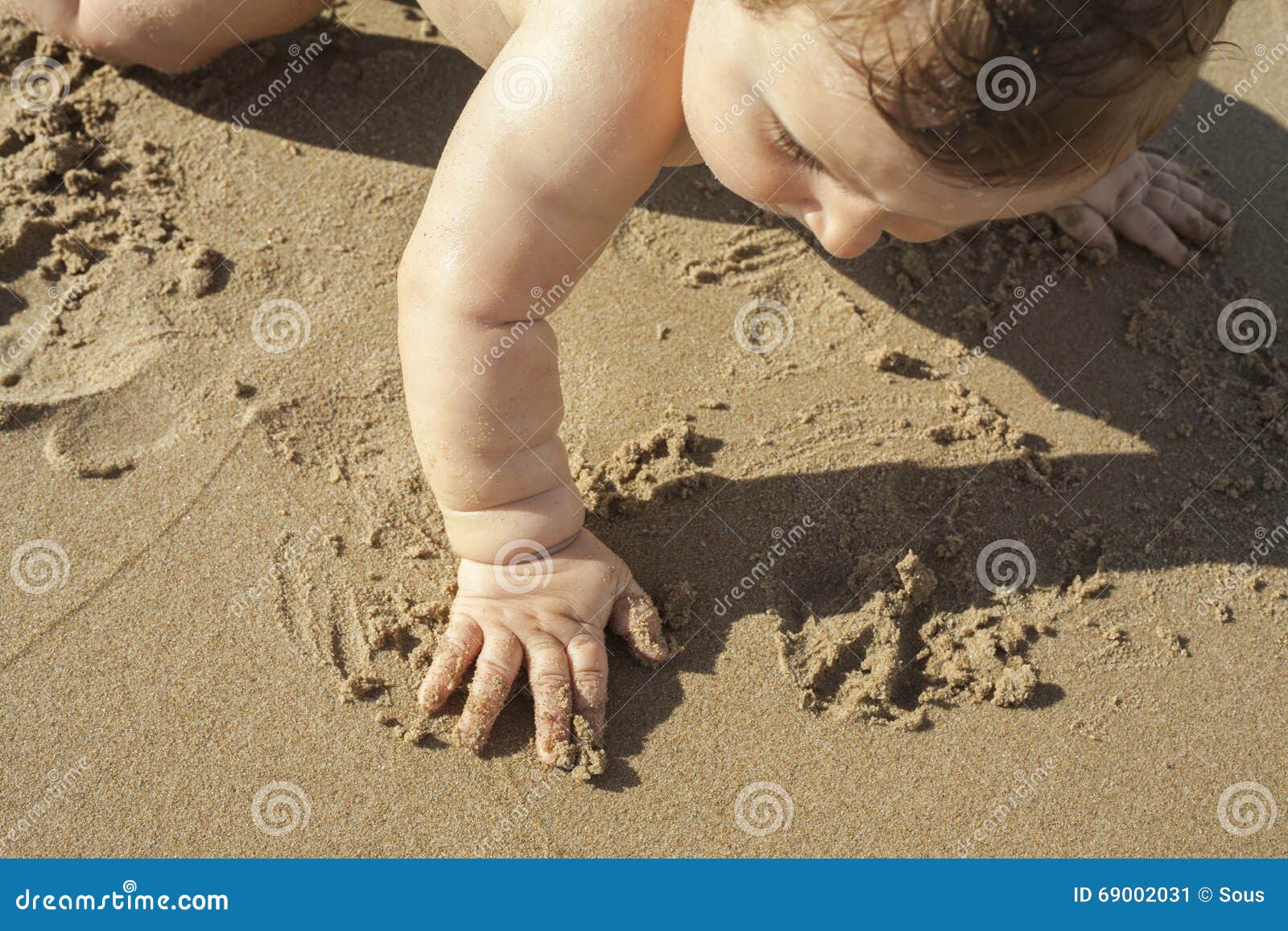 Baby Boy Touching the Sand in the Seashore. Stock Image - Image of ...