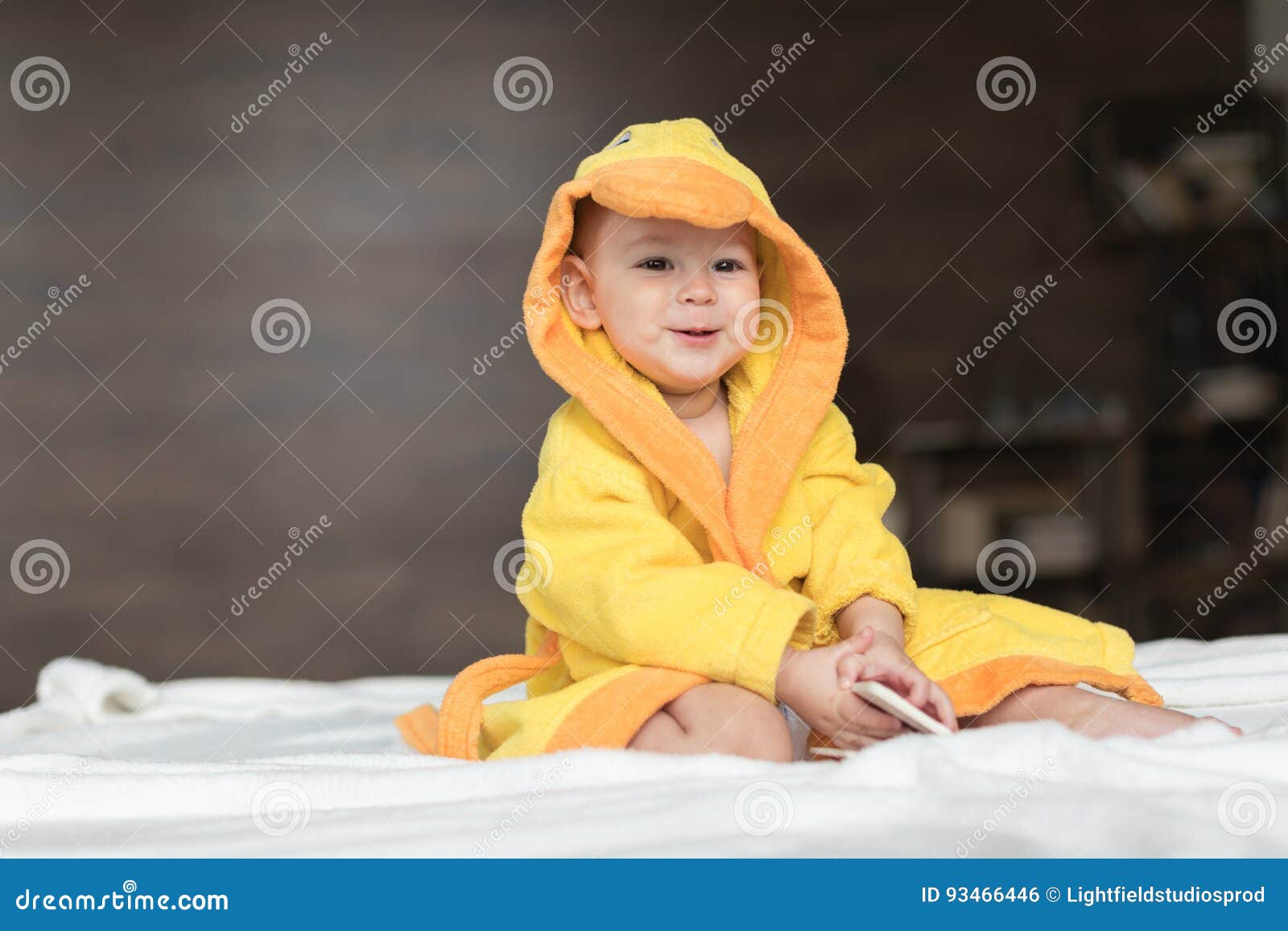 Baby boy in yellow robe stock photo. Image of indoor - 93466446