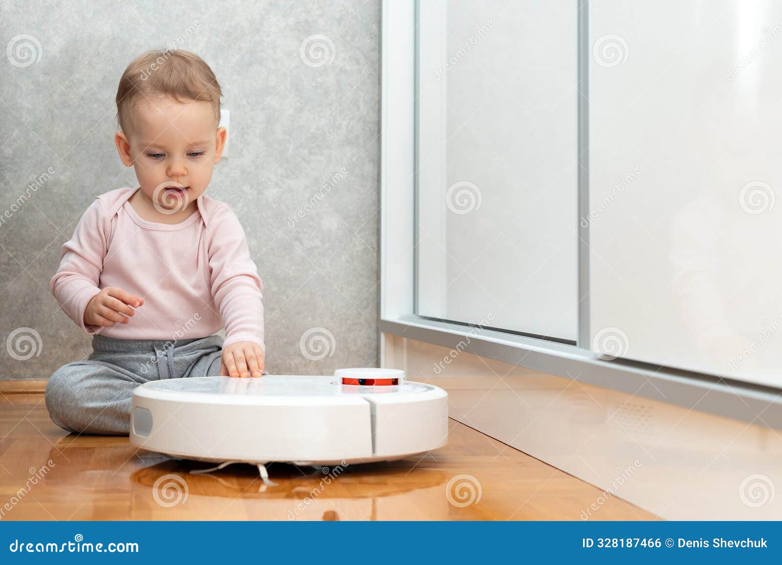 The Baby Carefully Feels the Robot Vacuum Cleaner. the Concept of ...