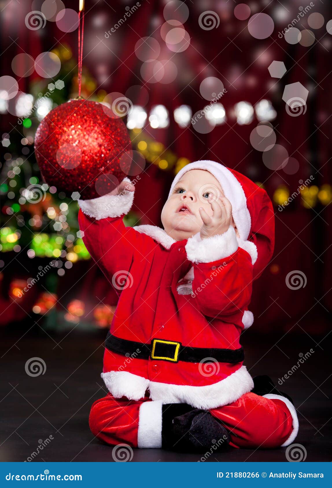 Baby Catching Christmas Ball Stock Photo - Image of christmas, glitter ...