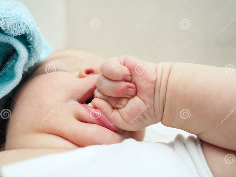 Baby chewing on hand stock image. Image of child, towel - 41005191