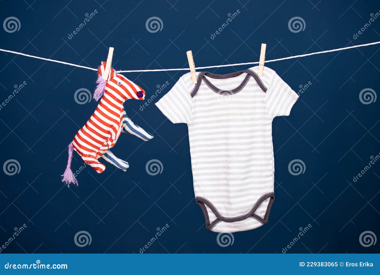 Baby Clothes Hanging on the Rope on Blue Background Stock Image - Image ...