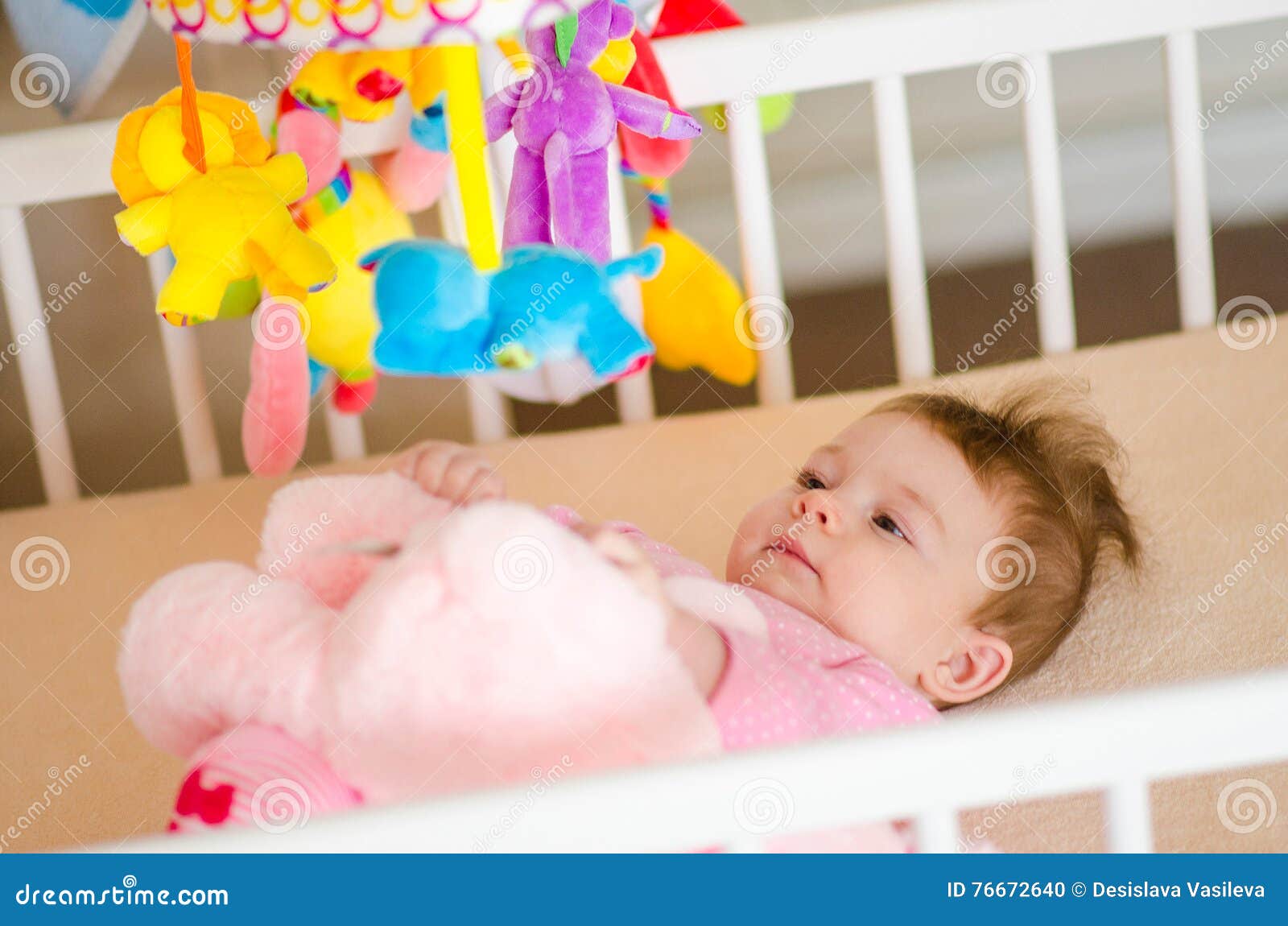 Baby in a cot stock photo. Image of child, wooden, toys - 76672640