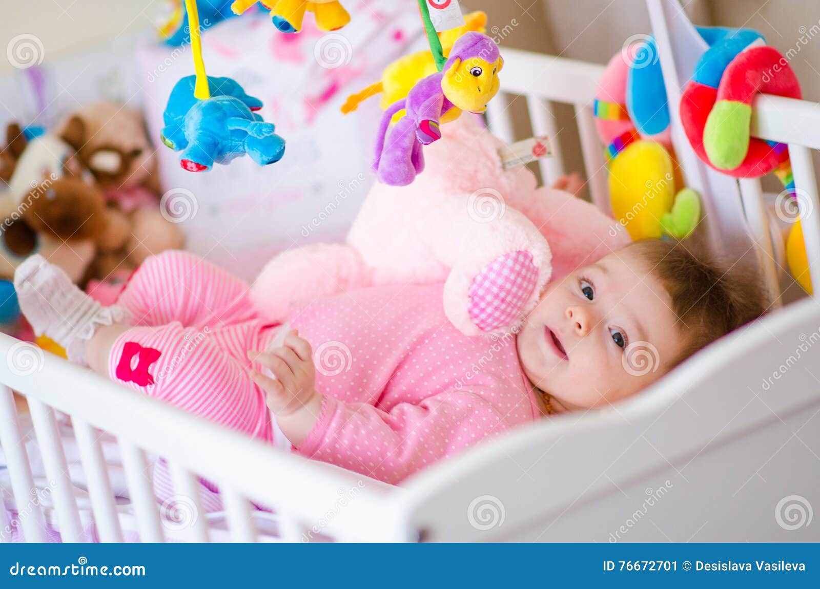Baby in a cot stock image. Image of wooden, pink, eyes - 76672701