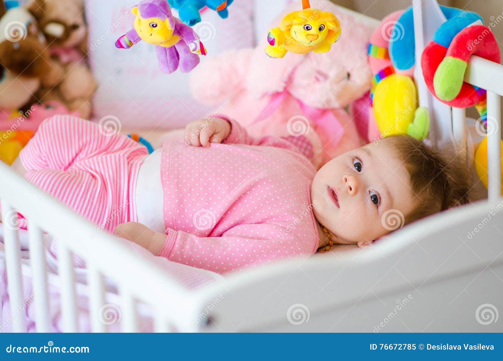 Baby in a cot stock image. Image of colorful, happy, newborn - 76672785