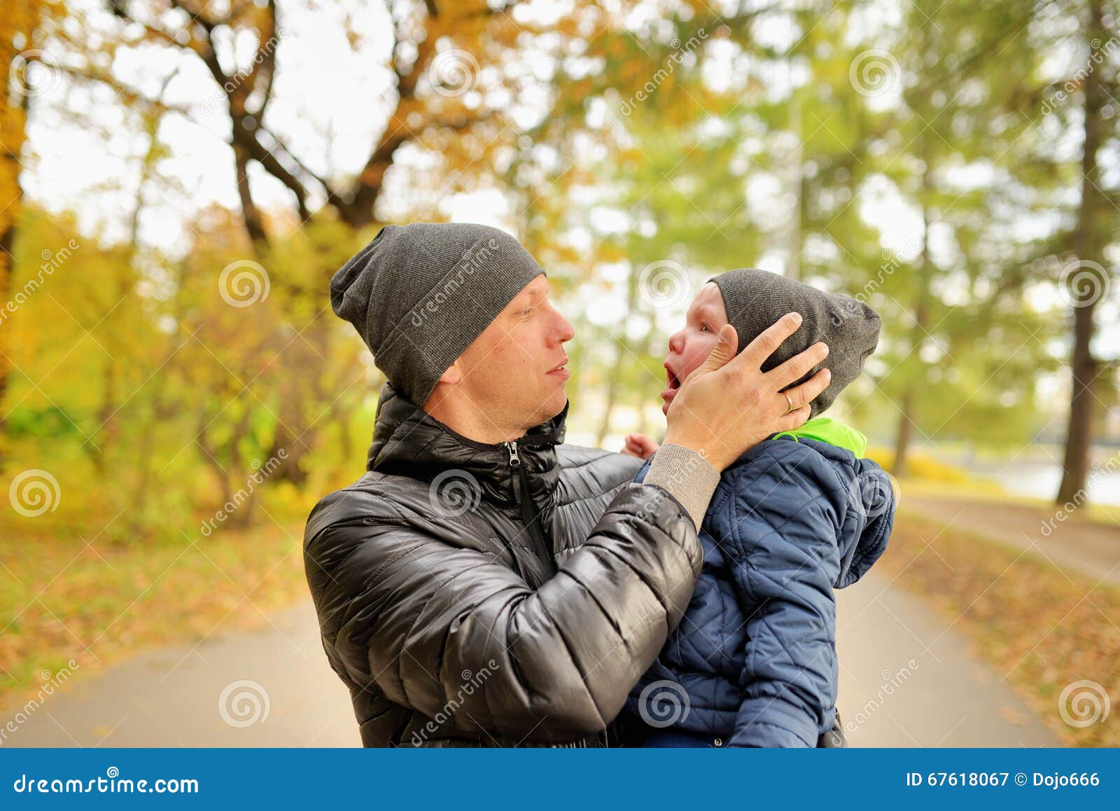 Baby Crying in Arms of His Father in Park Stock Image - Image of crying ...