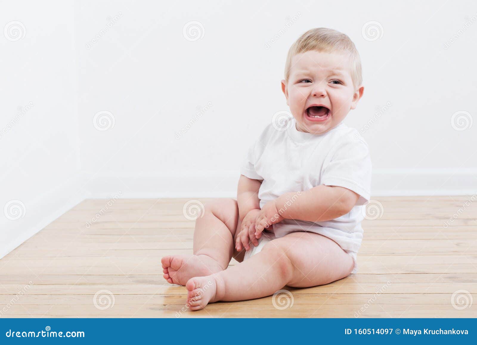 Baby Crying Sitting on Wooden Floor Stock Image - Image of crying ...
