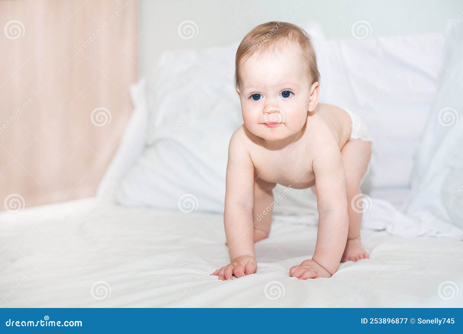 Baby in Diaper on Bed Close-up. Infant Learns To Crawl.. Stock Image ...
