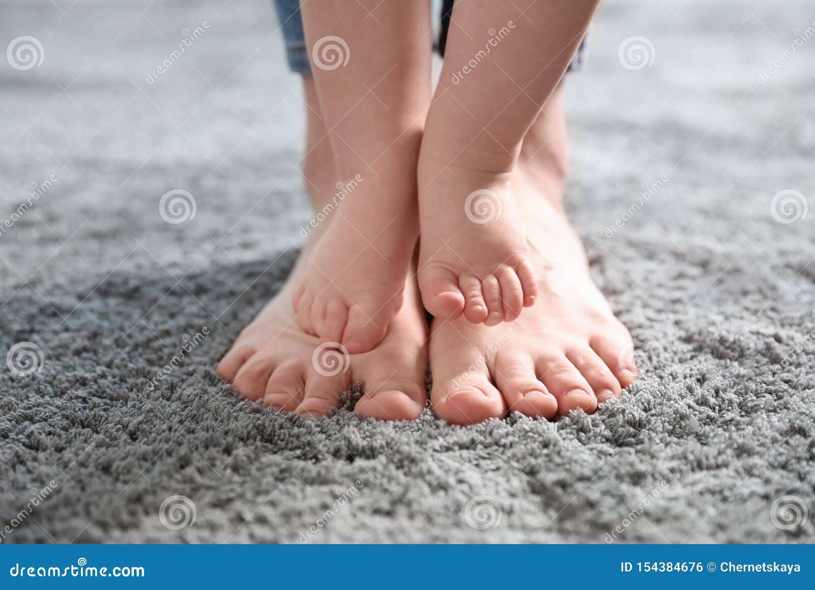 Baby Doing First Steps with Mother`s Help, Stock Photo - Image of grey ...
