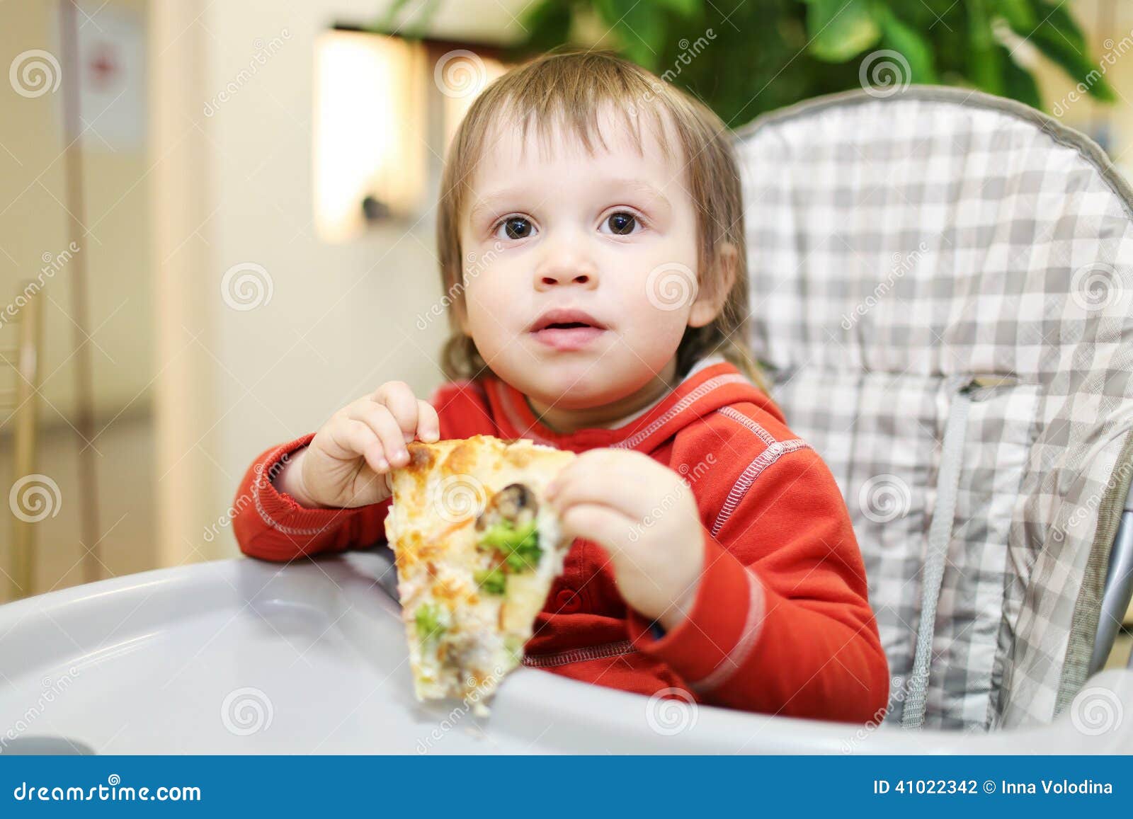 Baby eating pizza in cafe stock photo. Image of eating - 41022342