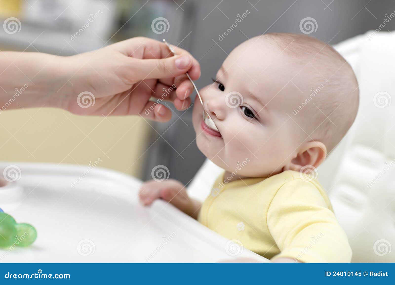 Baby eating with spoon stock image. Image of face, meal - 24010145