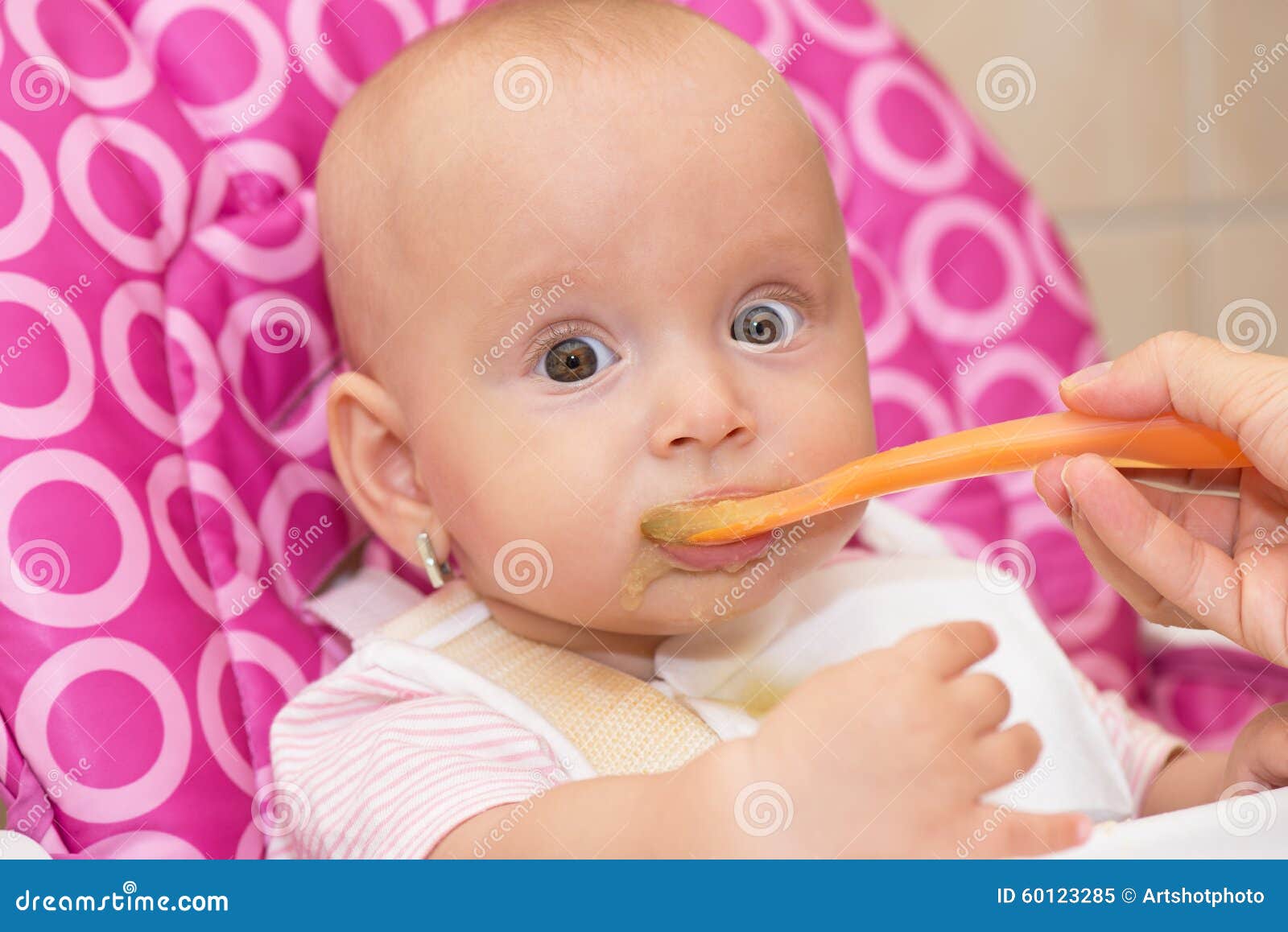Baby eating with spoon stock image. Image of expression - 60123285