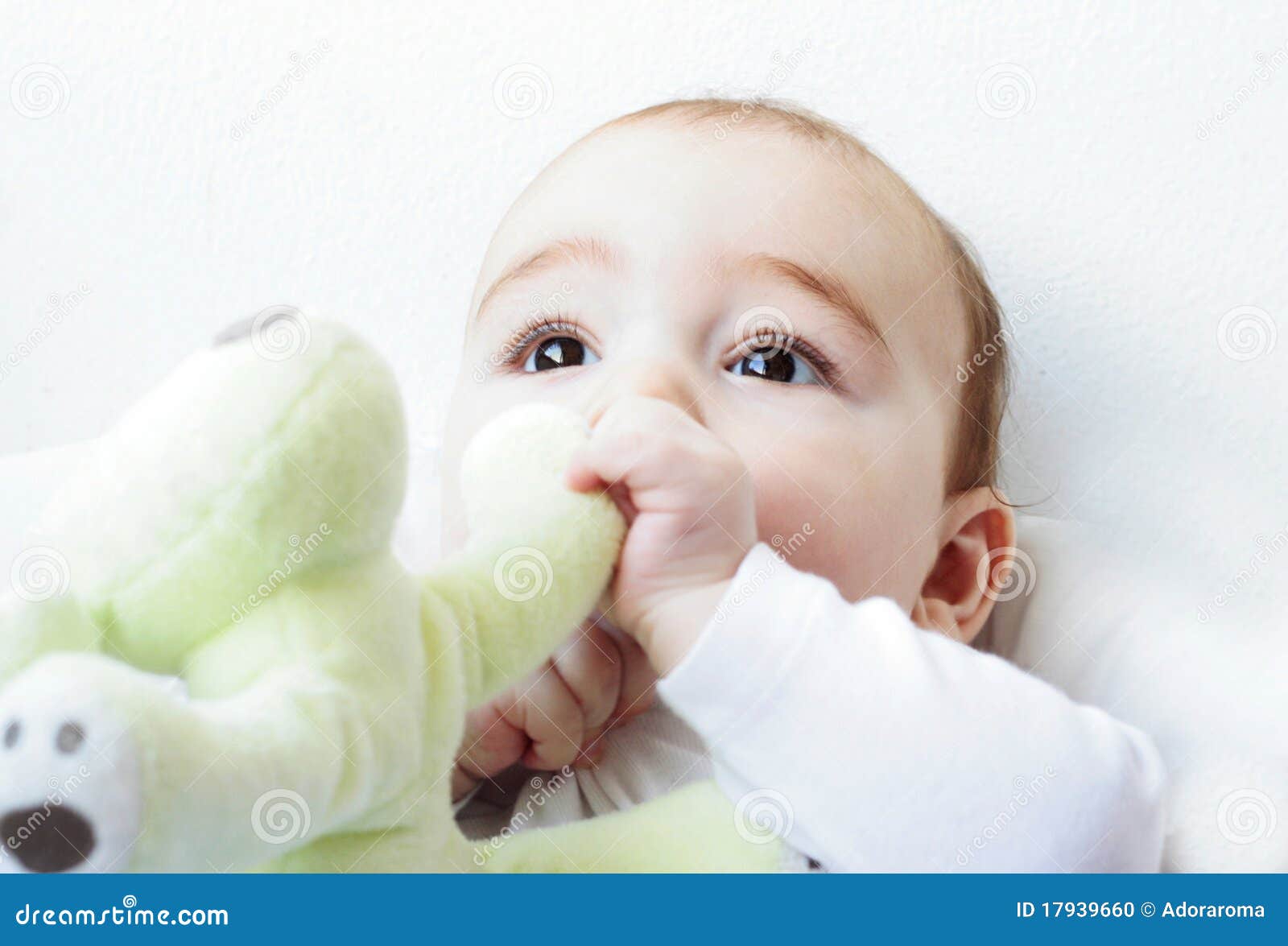 Baby eating a toy stock photo. Image of sweet, infancy - 17939660