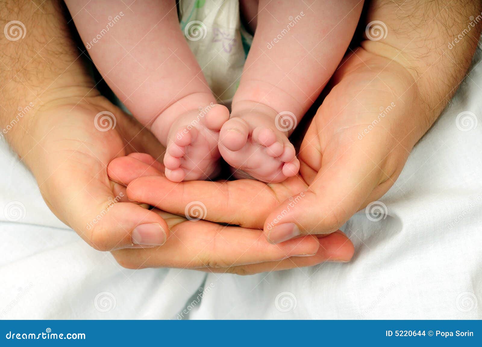 Baby feet in dads hand stock photo. Image of birth, holds - 5220644