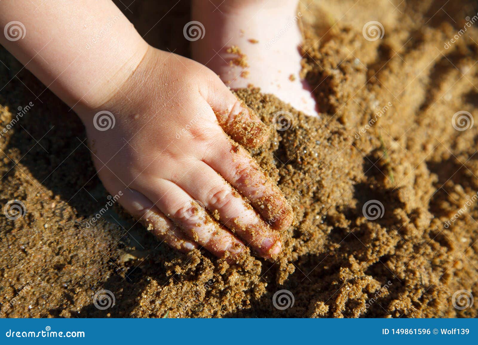Baby Feet and Hand in the Sand Stock Photo - Image of yellow, sand ...
