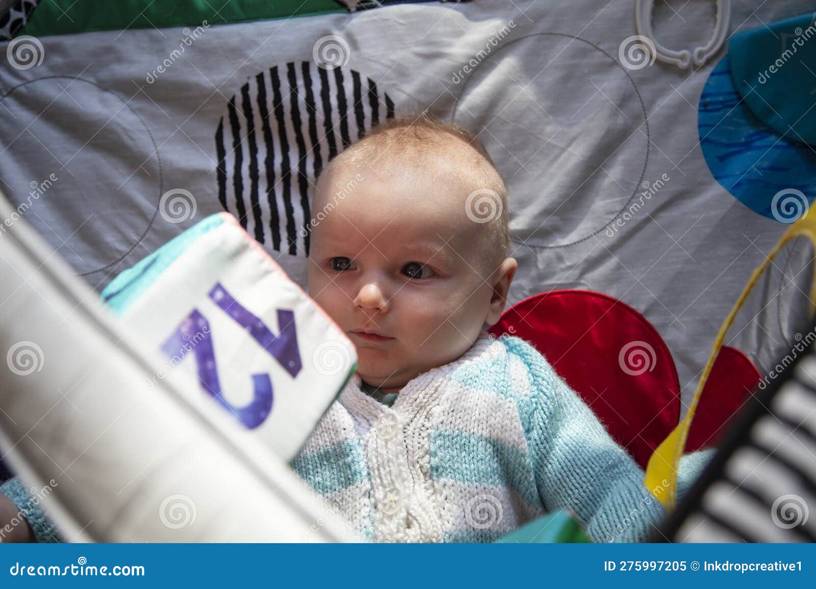 A Baby Focused on a Sensory Development Activity Playmat Stock Image ...