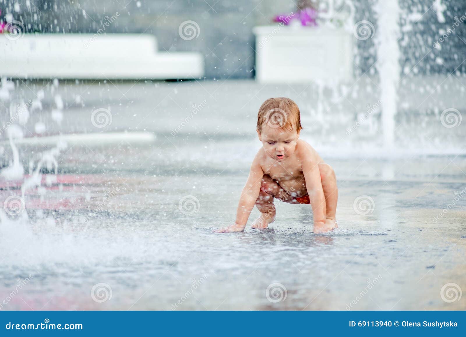 Baby in the fountain stock photo. Image of little, actions - 69113940