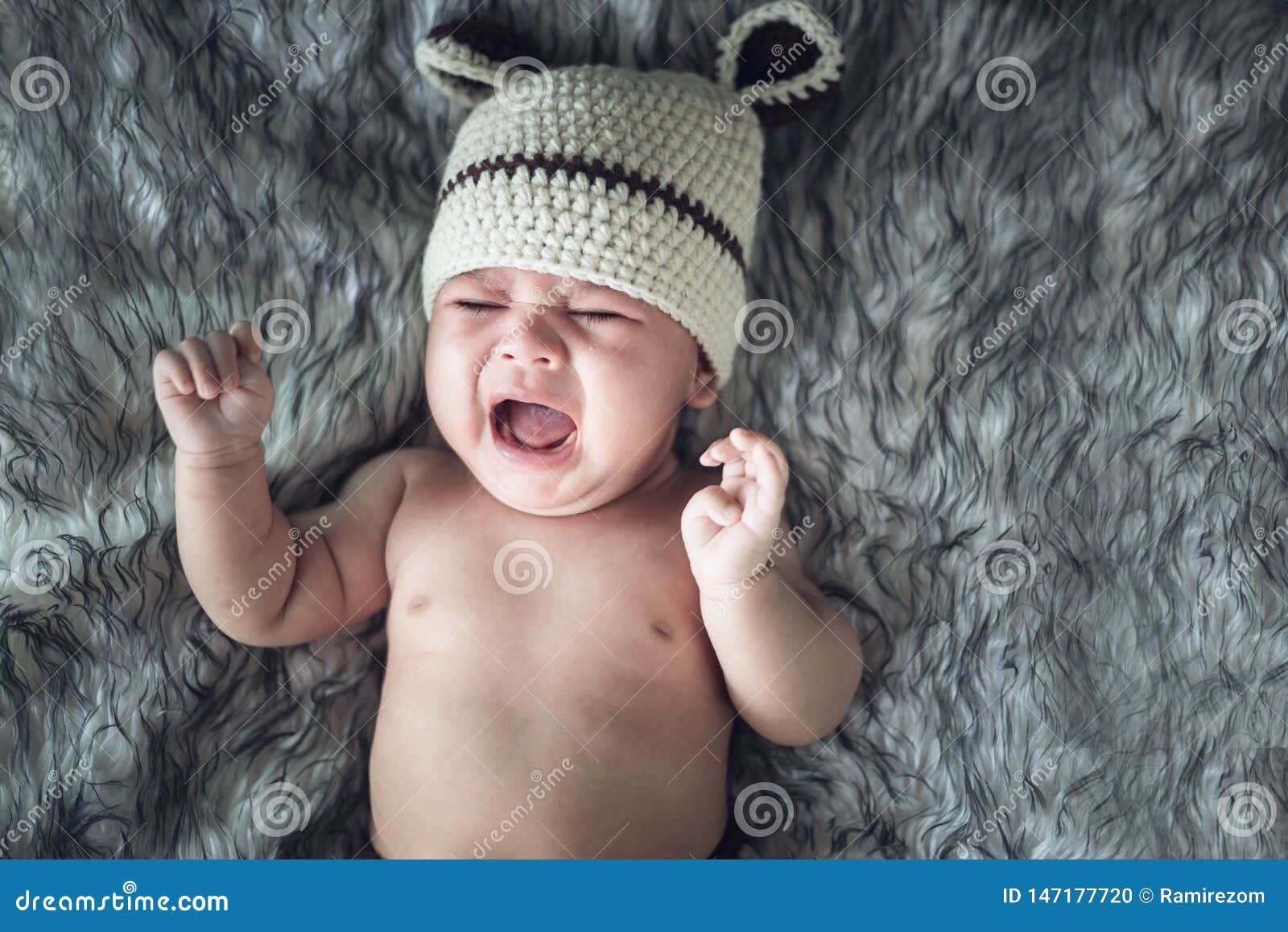 Baby girl crying in a wrap stock photo. Image of kids - 147177720