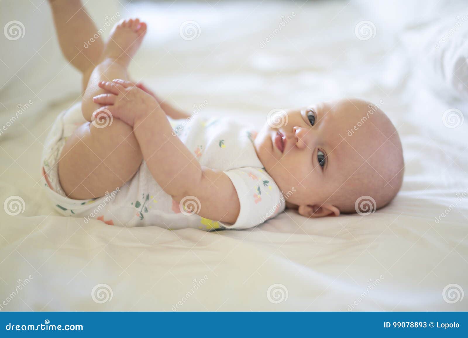 Baby Girl Laying on a White Bed Stock Image - Image of child, childhood ...