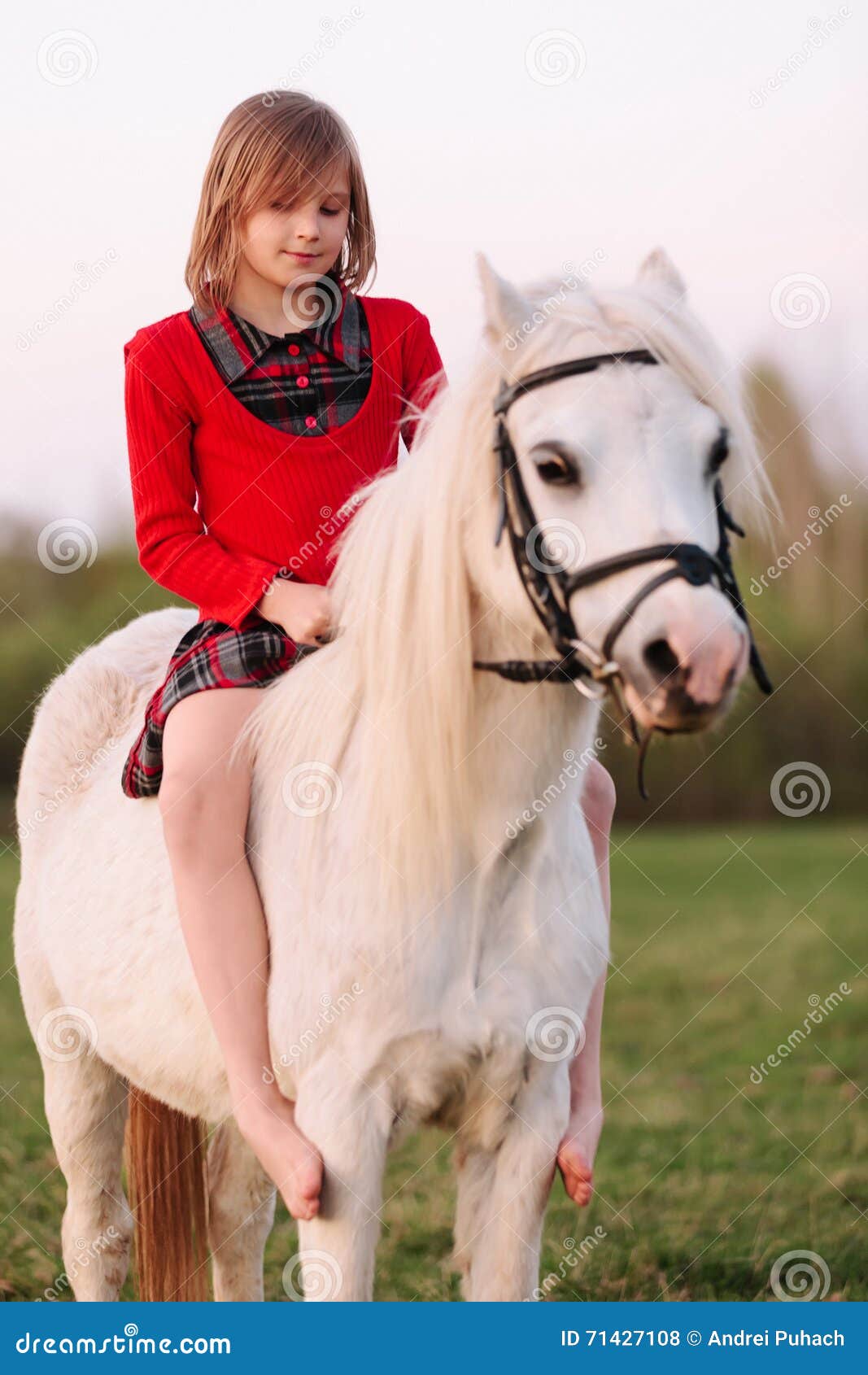 The Baby Girl is Sitting on a Pony Thoughtful Stock Photo - Image of ...