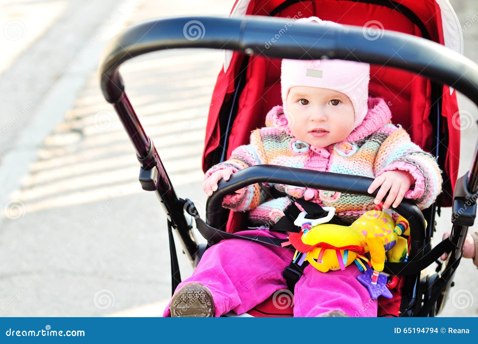 Baby girl in the stroller stock photo. Image of childhood - 65194794