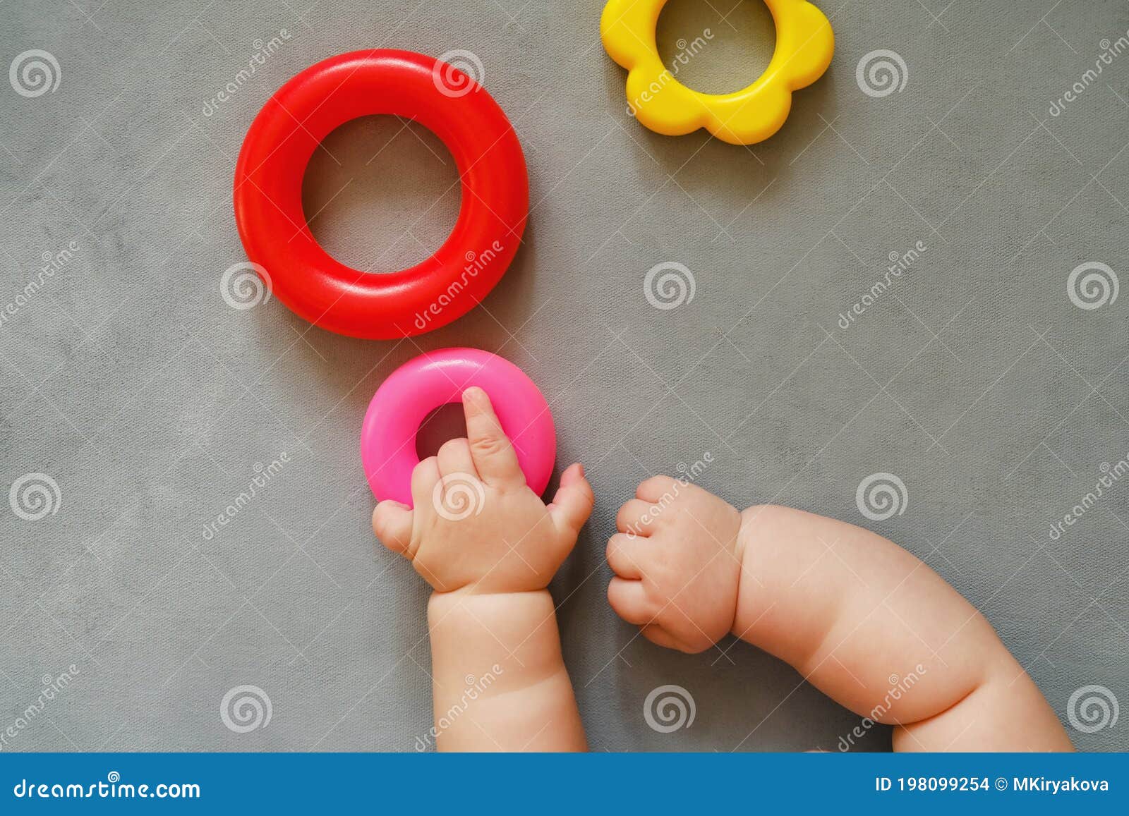 Baby Hand Playing with Plastic Toys. Developing Toys, Early Baby ...