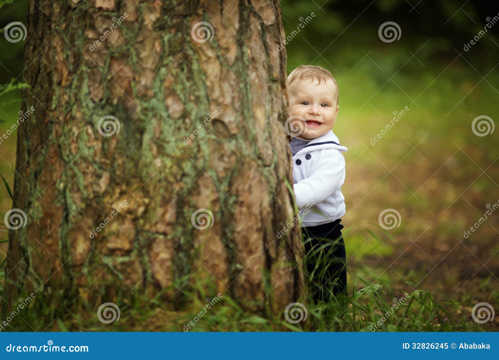 Baby Hiding Behind Tree in Park Stock Image - Image of outdoor, person ...