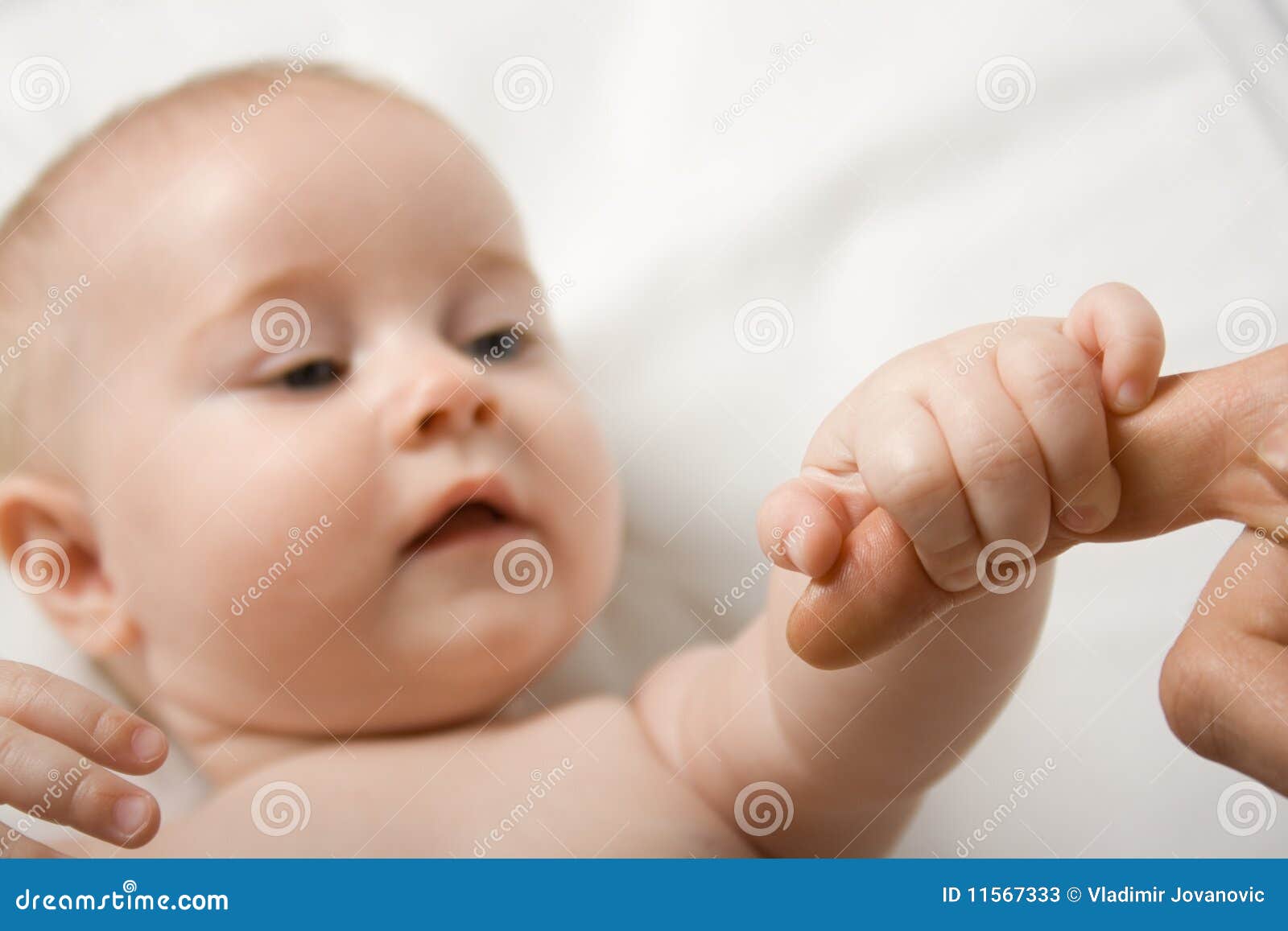 Baby hold mothers hand stock image. Image of towel, eyes - 11567333
