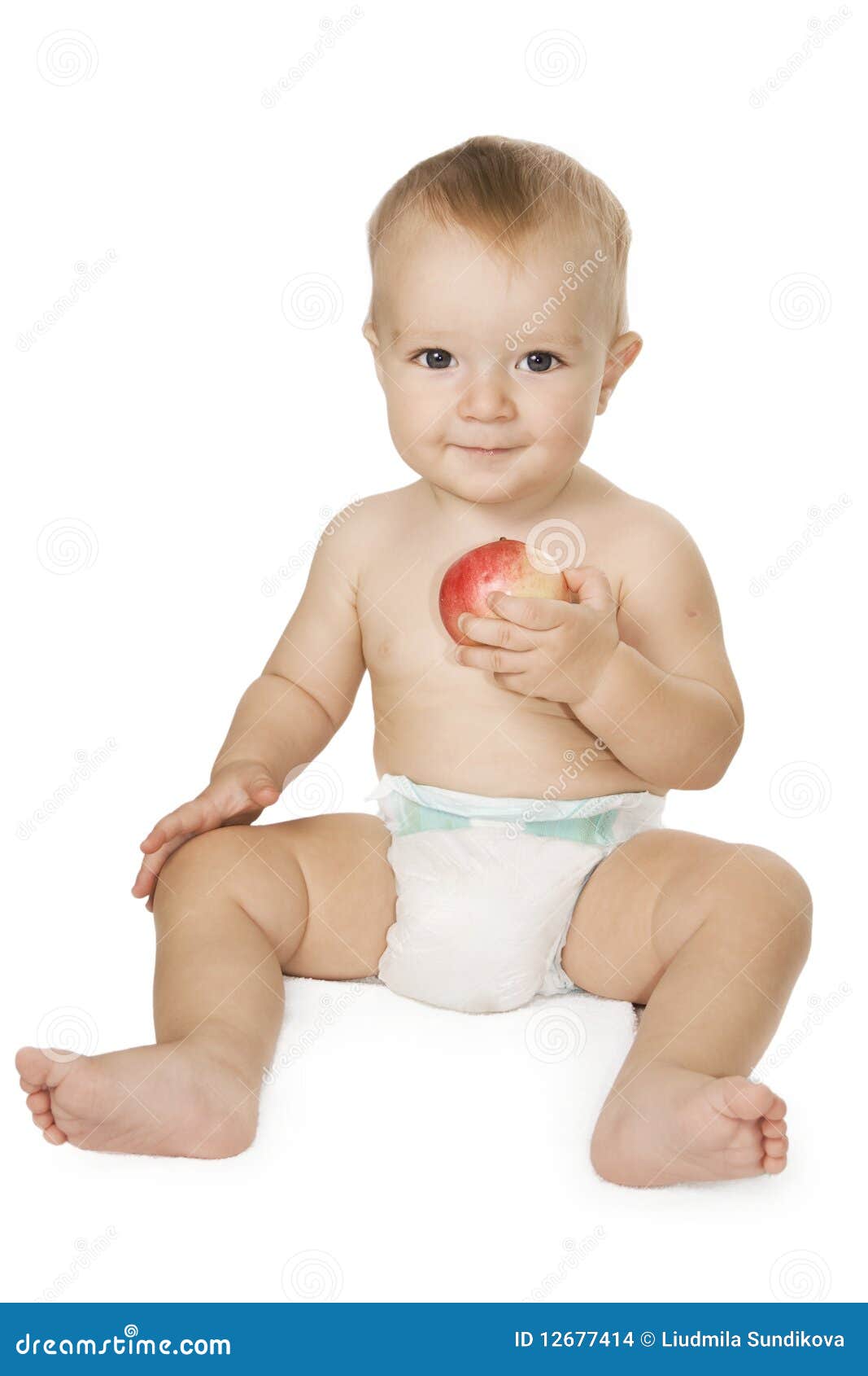 Baby holding an apple. stock photo. Image of additional - 12677414