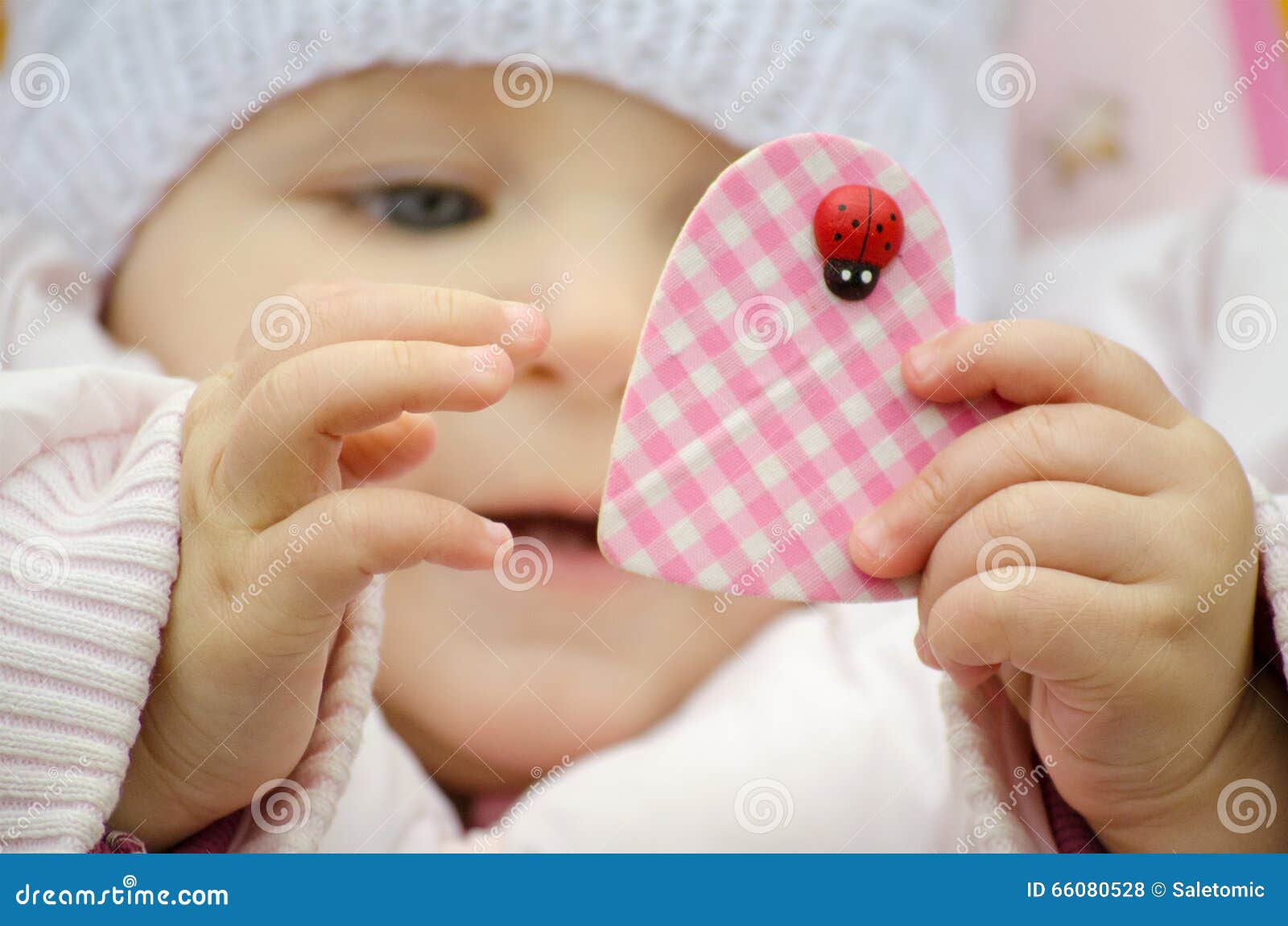 Baby holding a heart stock photo. Image of cute, girl - 66080528