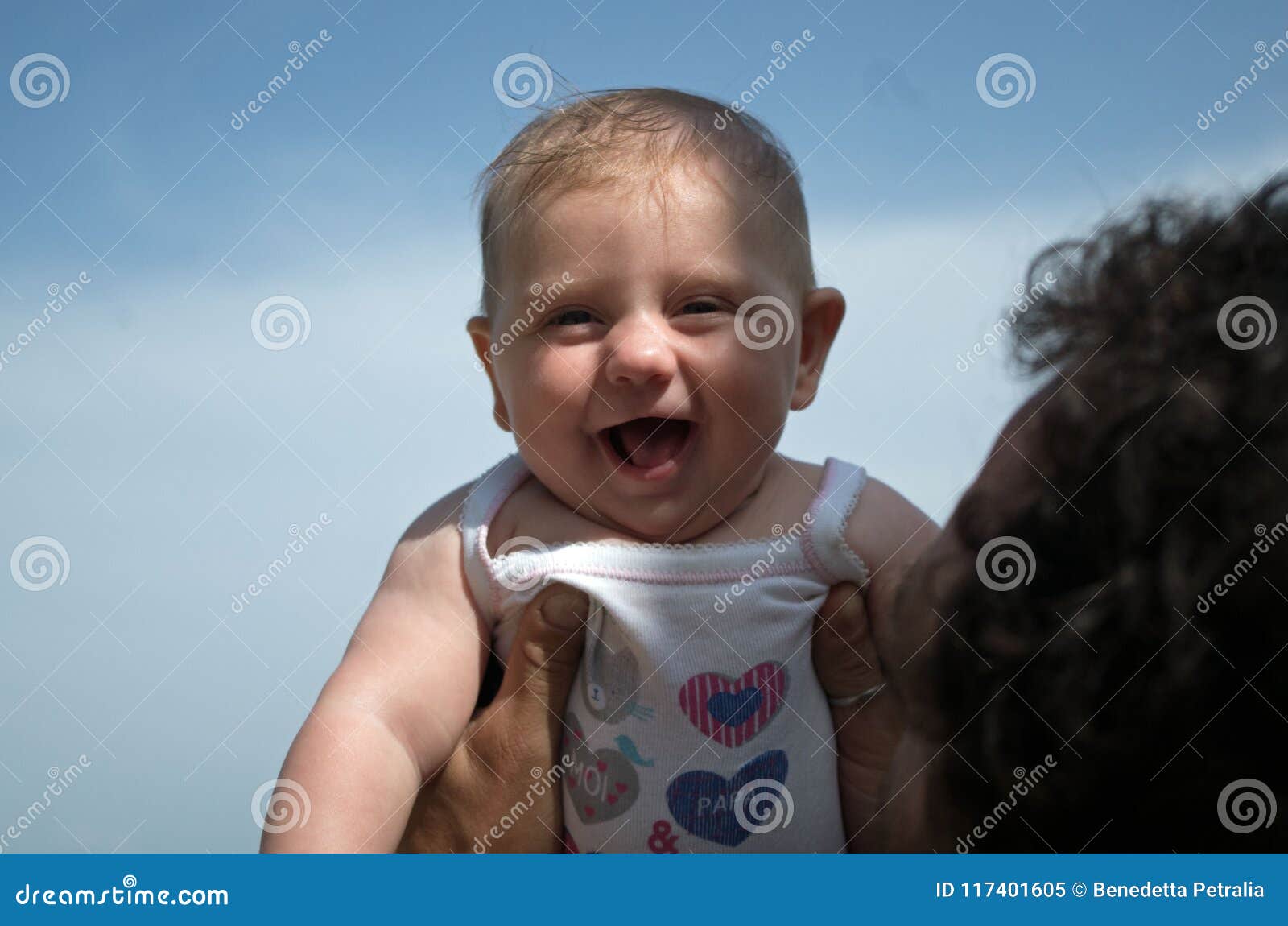 Baby laughing on blue sky stock image. Image of whand - 117401605