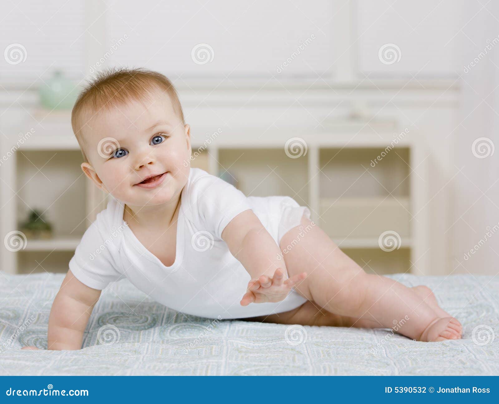 Baby laying on bed stock photo. Image of gleeful, color - 5390532