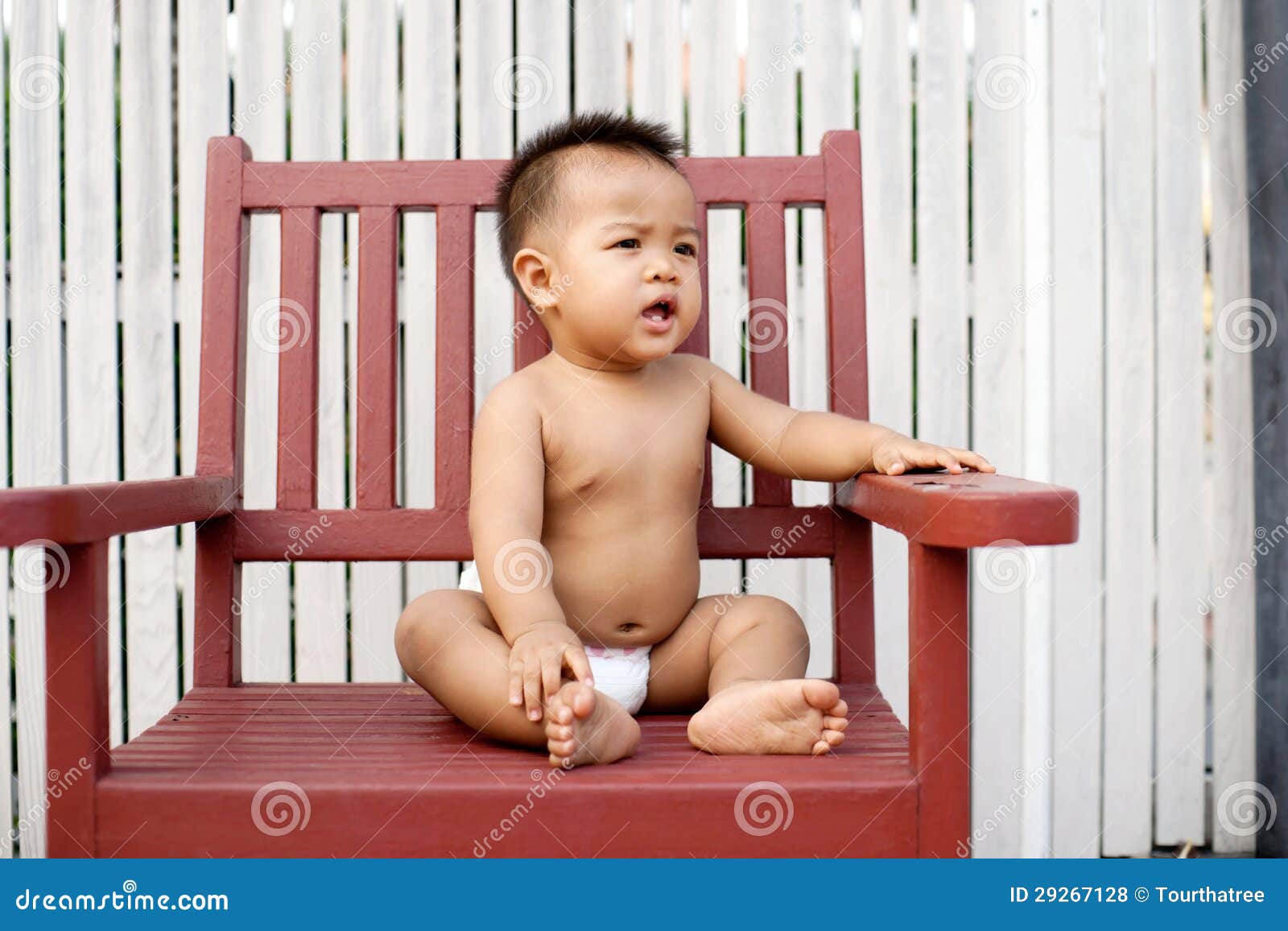 Baby laying on the chair stock photo. Image of face, adorable - 29267128