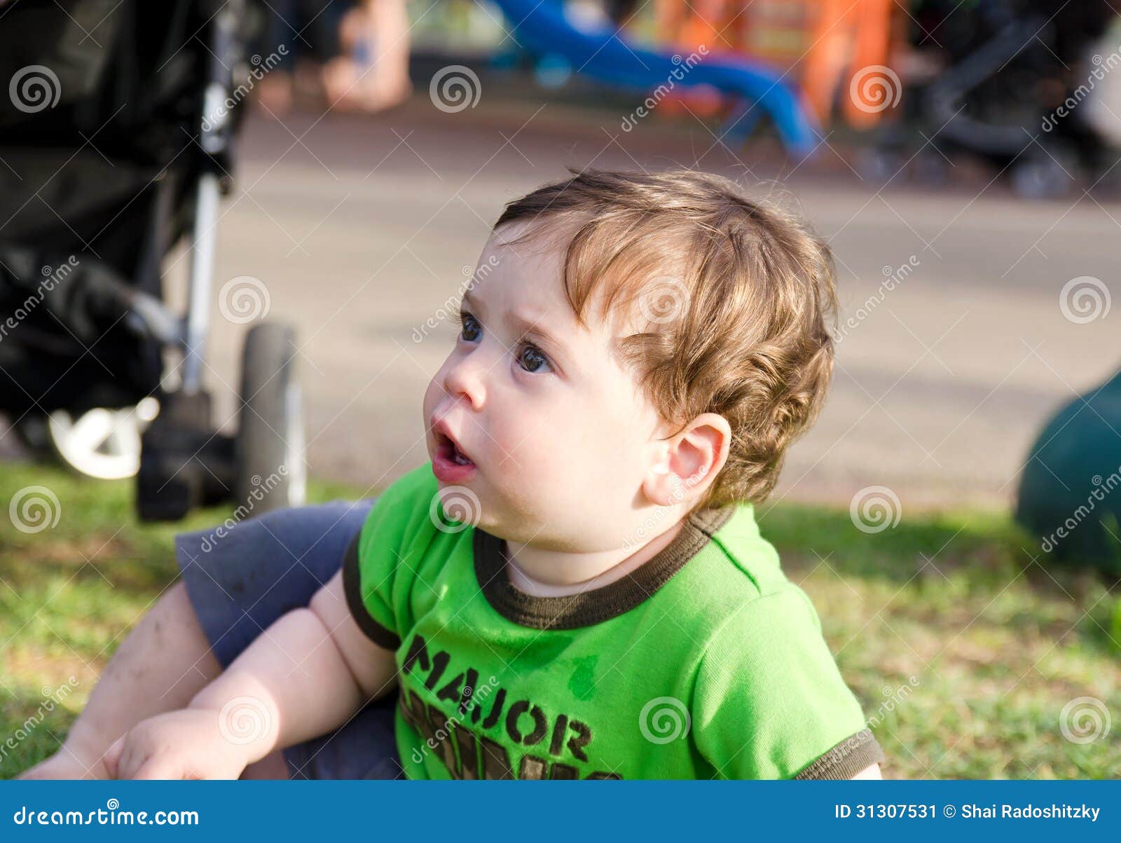 Baby leaning on the grass stock image. Image of hair - 31307531