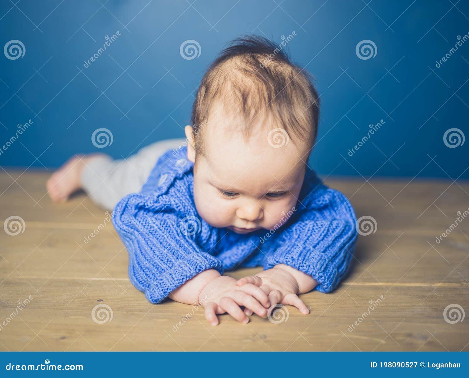 Baby learing to crawl stock image. Image of blue, child - 198090527