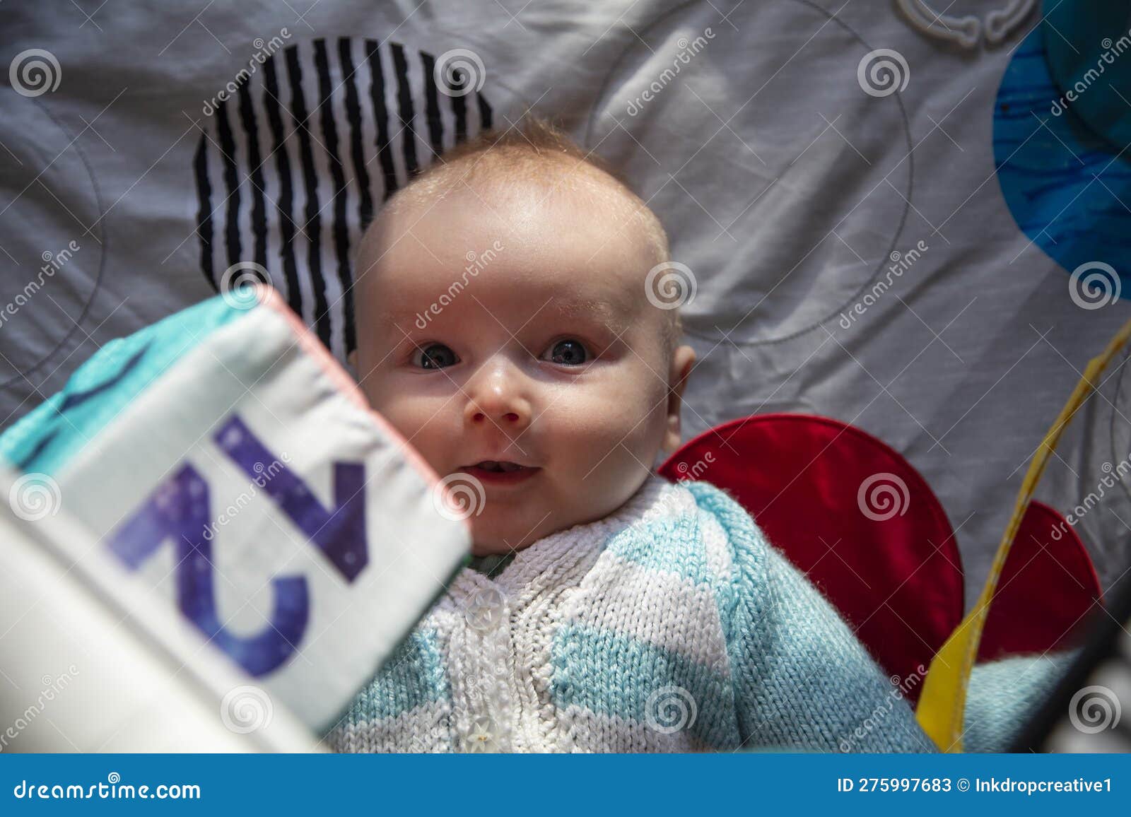 A Baby Looking at the Camera Playing on a Sensory Development Activity ...