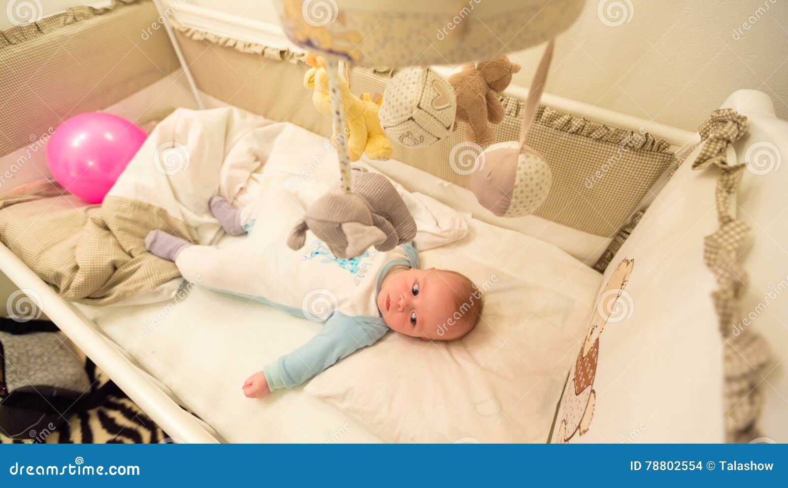 Baby lying in his cot stock photo. Image of childhood - 78802554