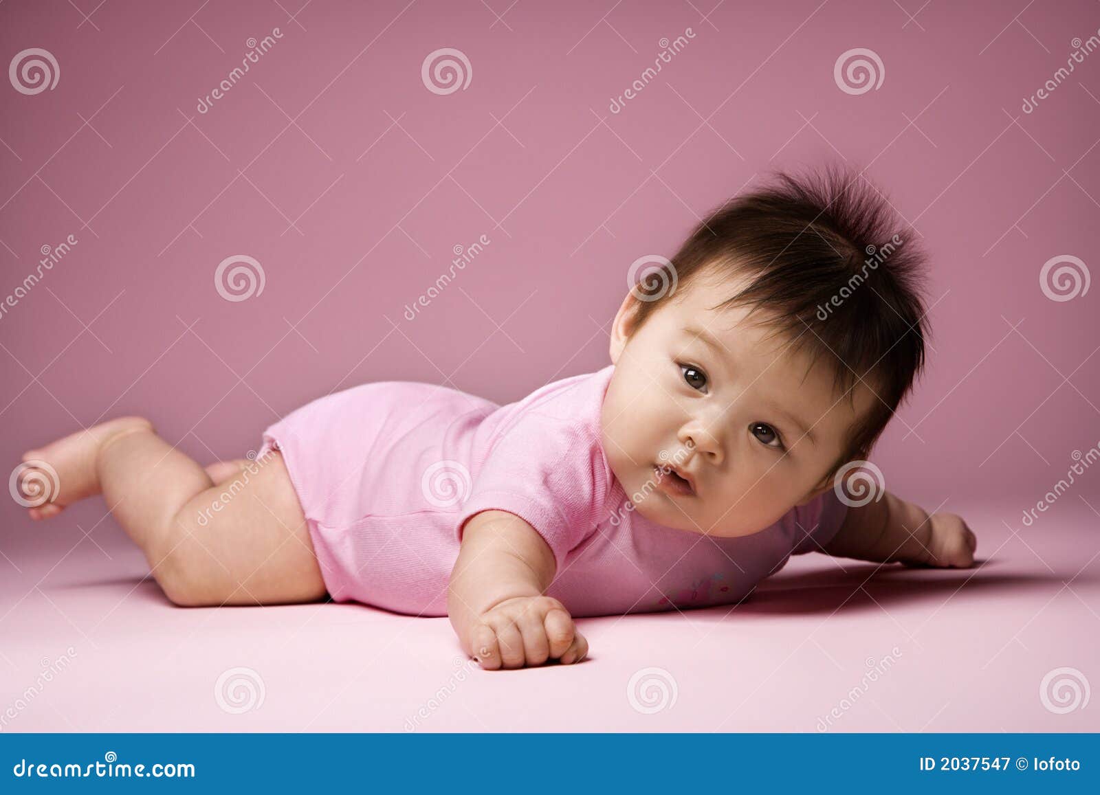 Baby Lying on Stomach Looking at Viewer. Stock Image - Image of female ...