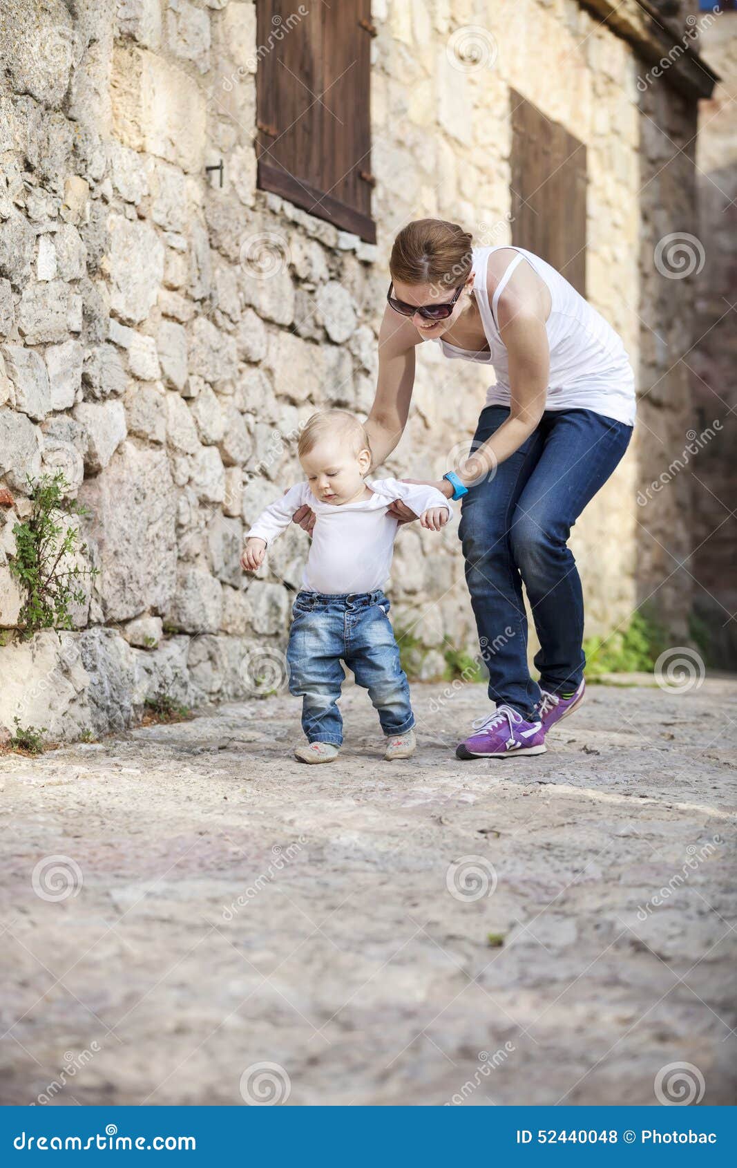 Baby Makes His First Steps with Help of His Mother Stock Photo - Image ...