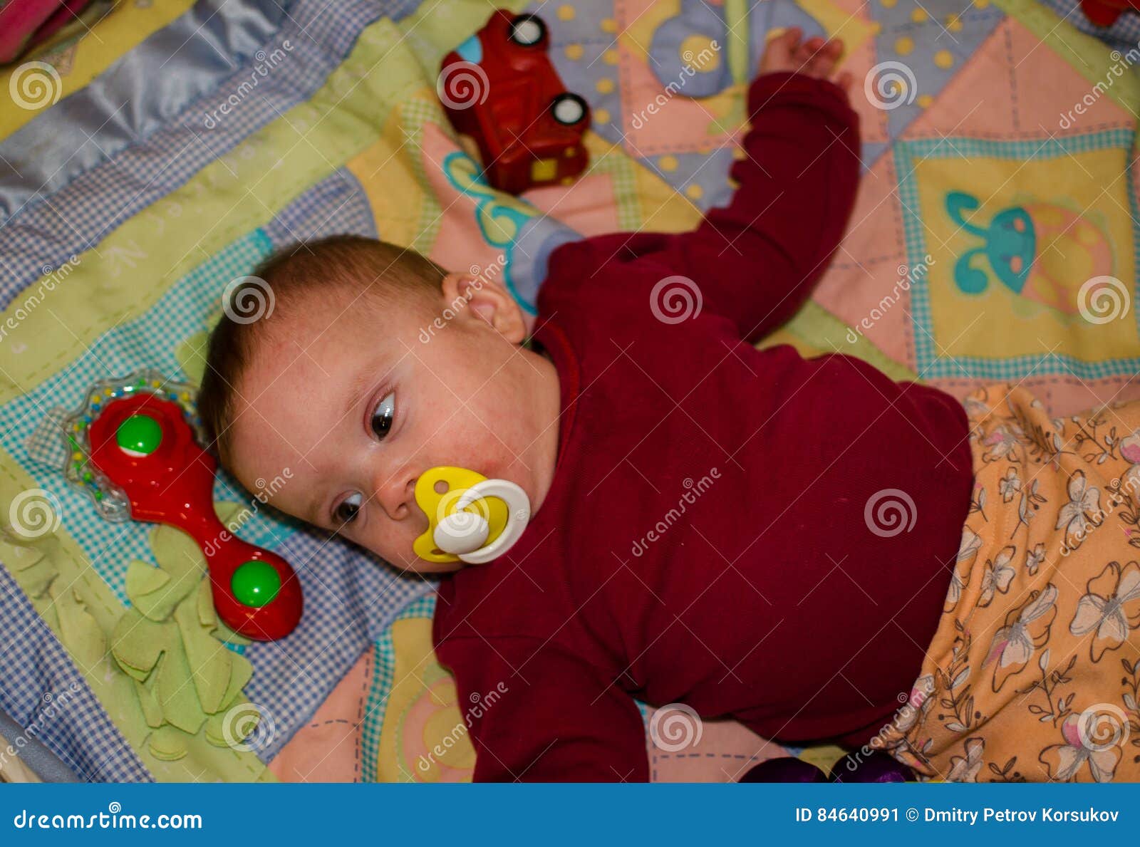 A Baby with a Pacifier Laying on the Bed Stock Image - Image of ...