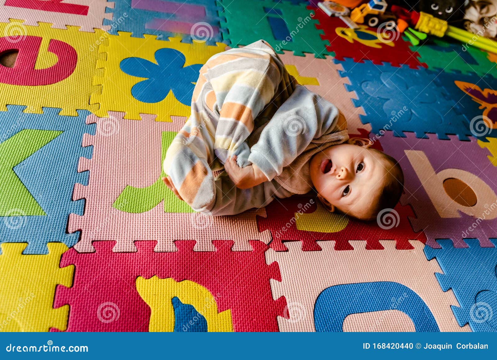 Baby in Pajamas Doing Yoga Lying on the Floor To Develop Stock Photo ...