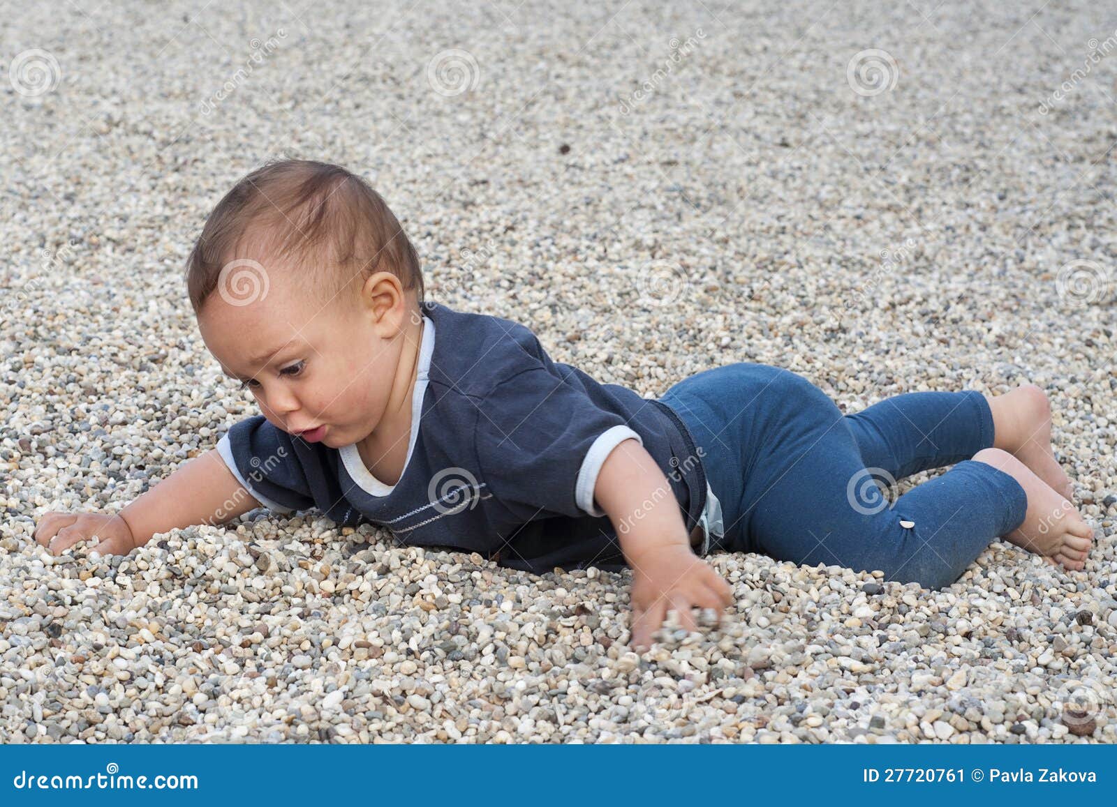 Baby in pebbles stock image. Image of beach, shore, stone - 27720761
