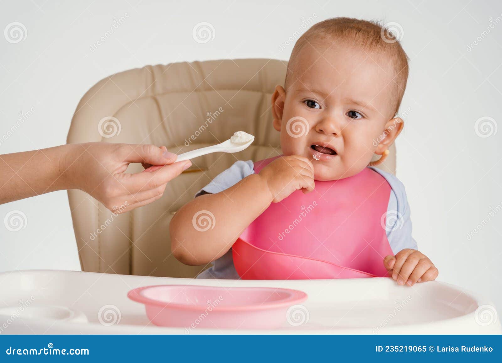 A Baby in a Pink Bib Refuses To Eat with a Spoon Stock Image - Image of ...