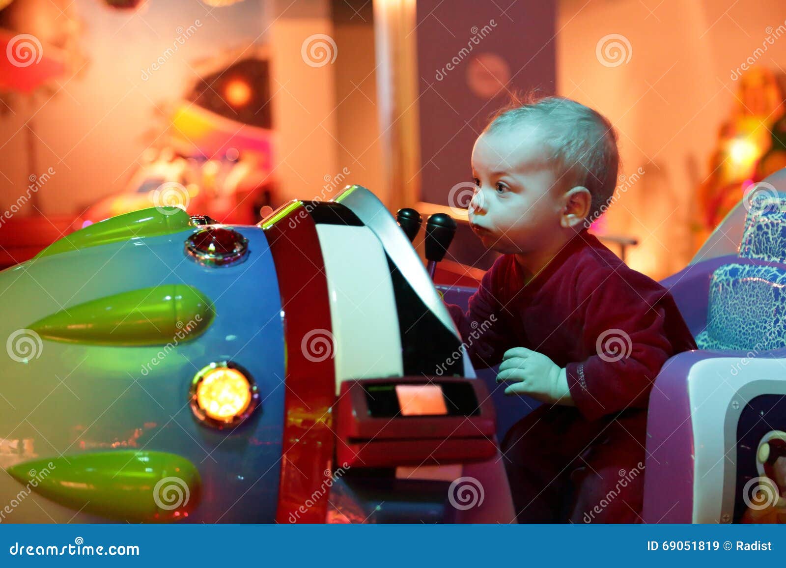 Baby Playing Arcade Game Machine Stock Image - Image of playful, drive ...