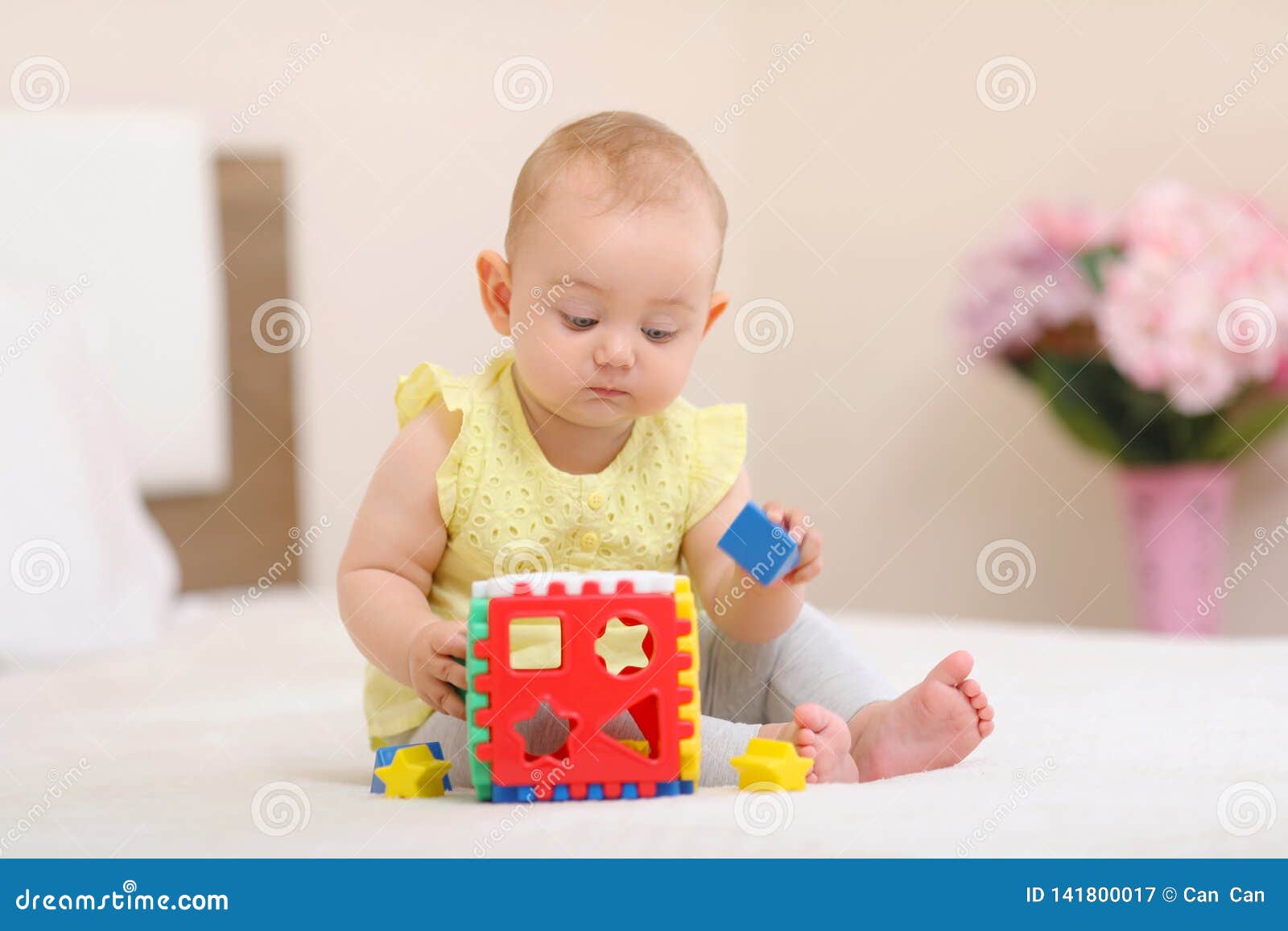 Baby is playing in bed. stock image. Image of dessert - 141800017