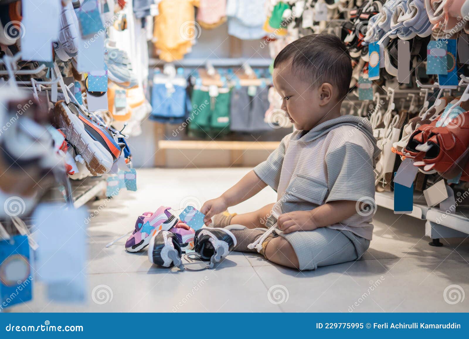Baby Playing and Crawling in the Store while Shopping Stock Image ...