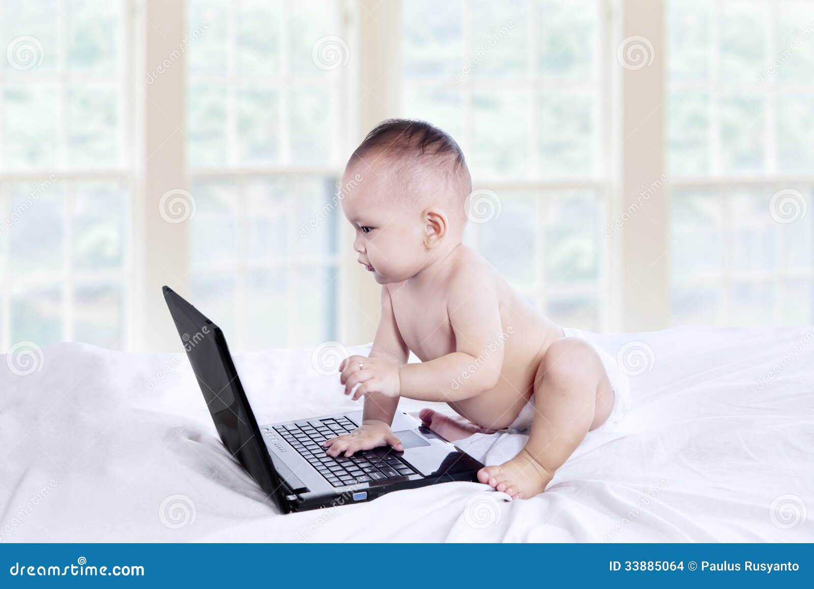 Baby playing with laptop stock photo. Image of concentration - 33885064
