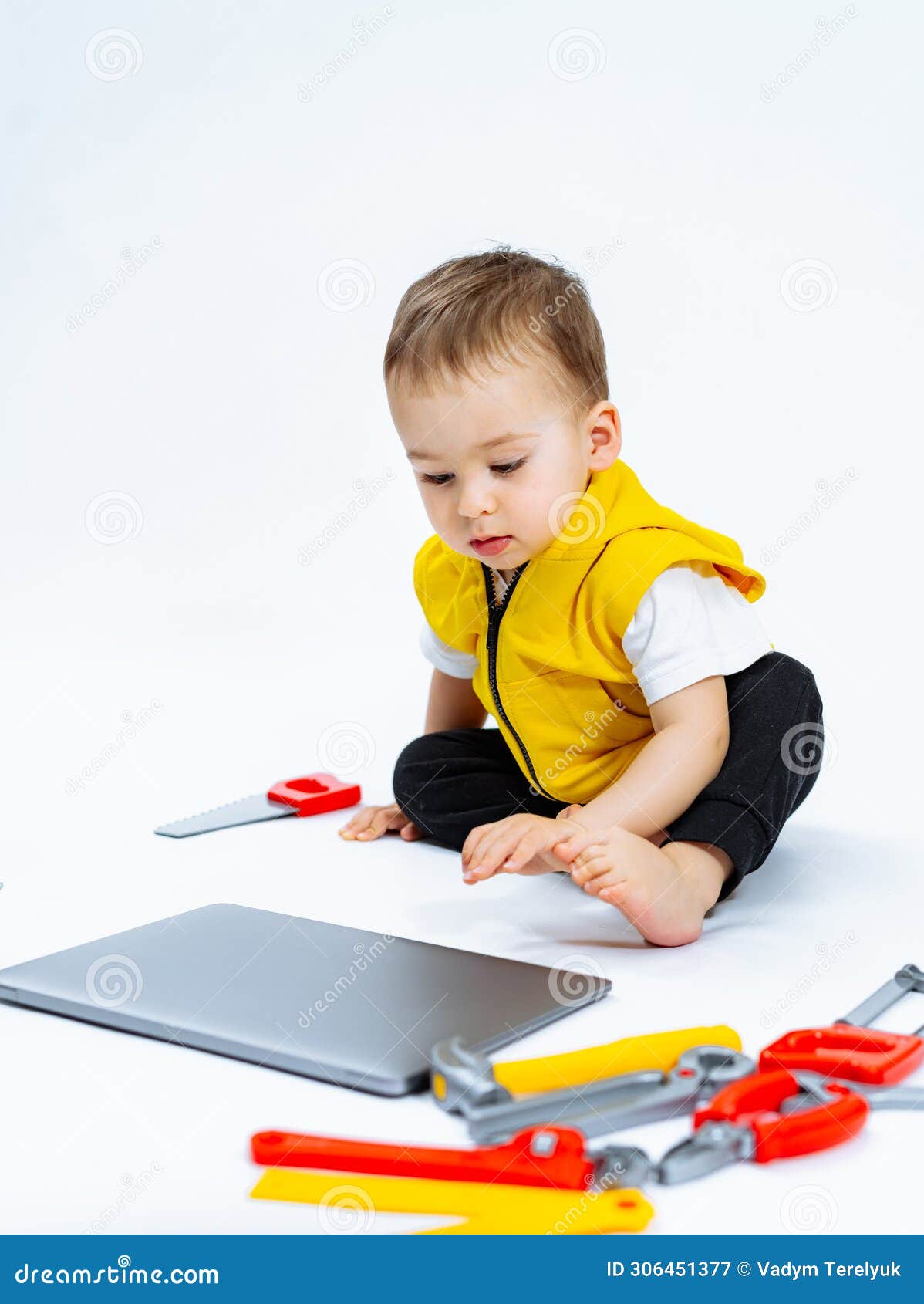 Baby Playing with Tools on the Floor. a Baby Sitting on the Floor ...