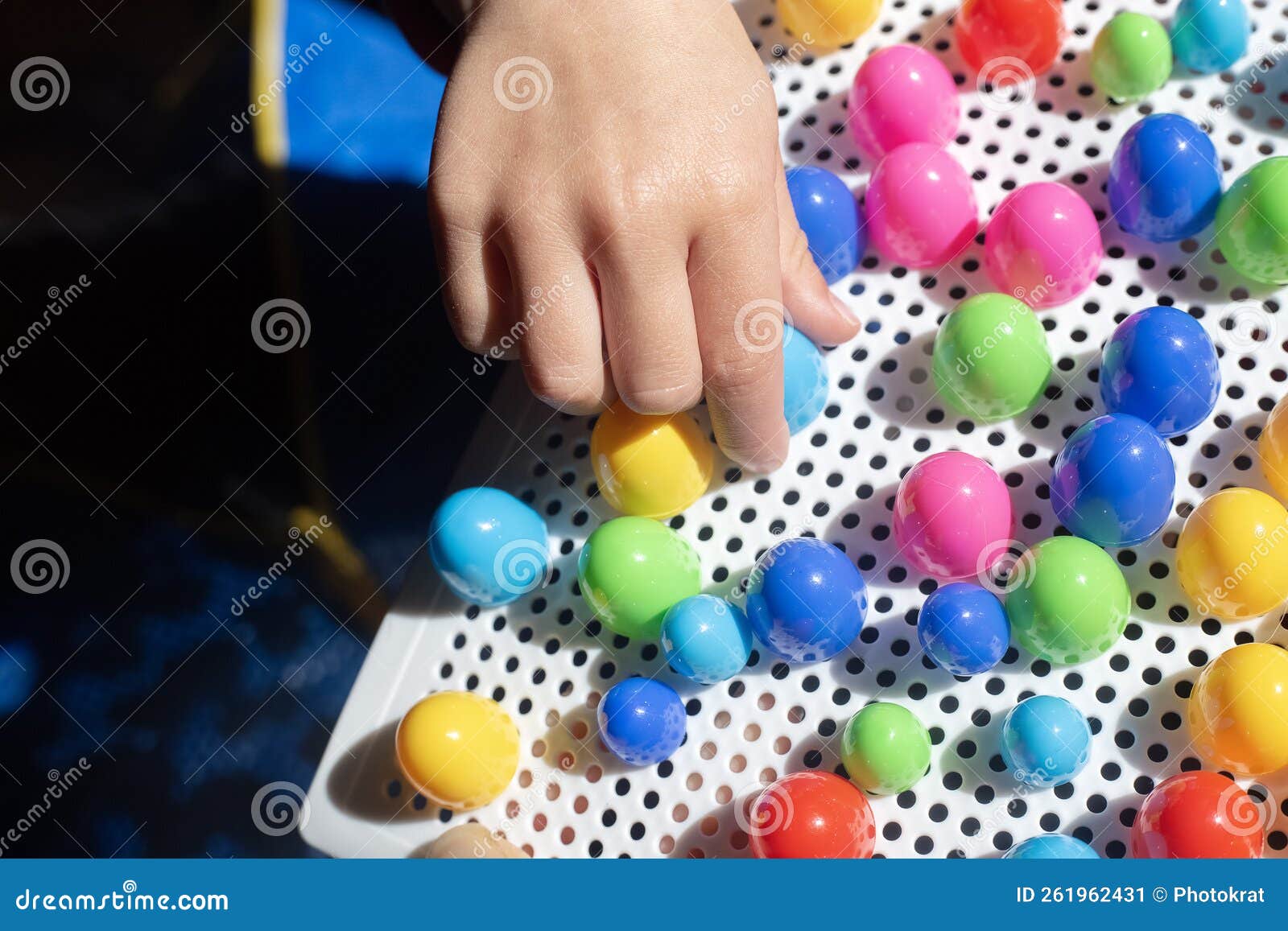Baby Plays with Colourful Mosaics on White Surface. Kids Hand with ...